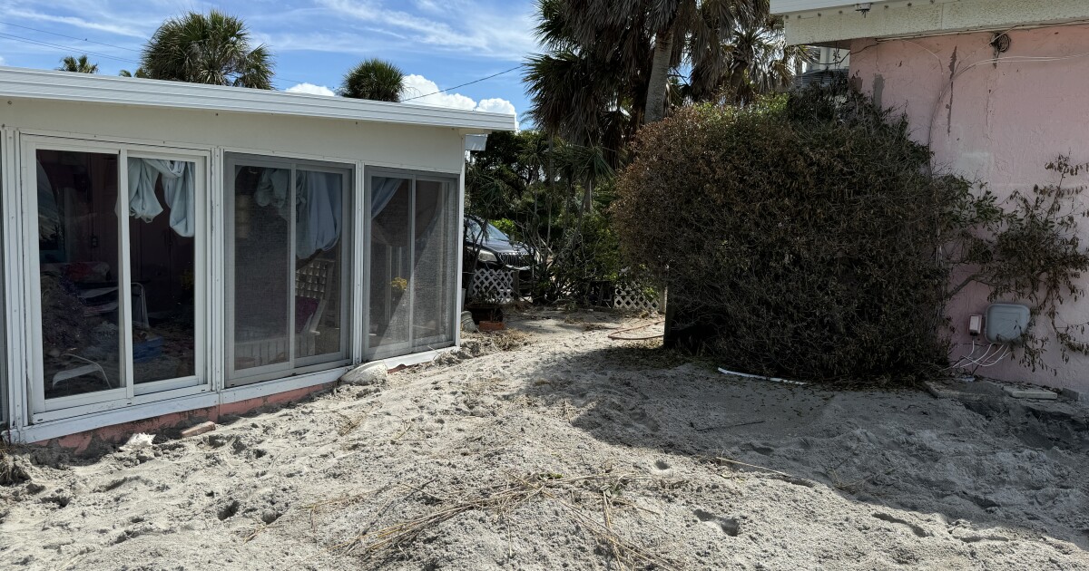 Longboat Key residents cleanup the mountains of sand, and water damage