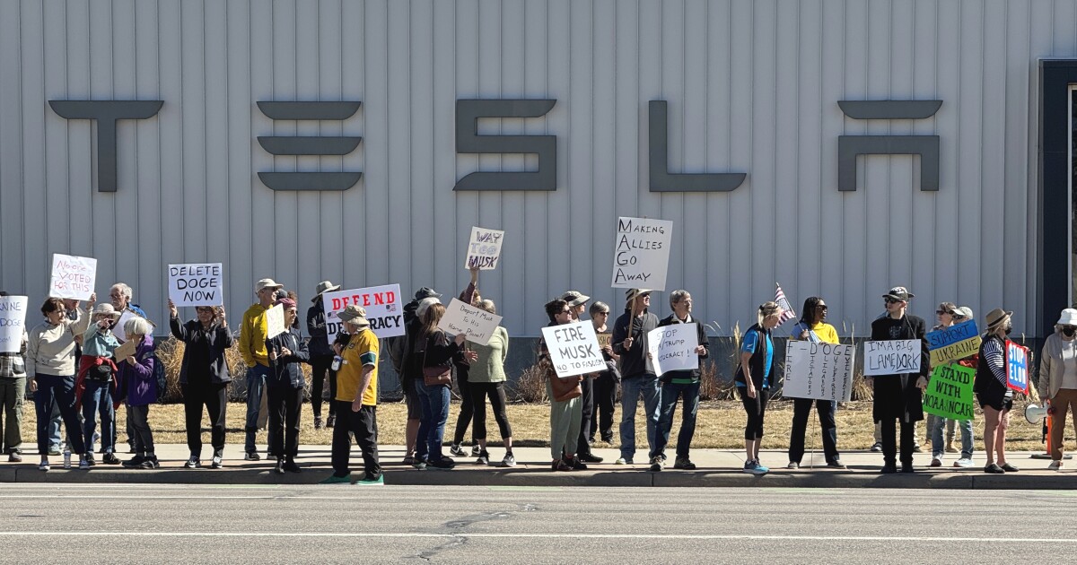 Hundreds gather at Superior Tesla dealership to protest Elon Musk's DOGE