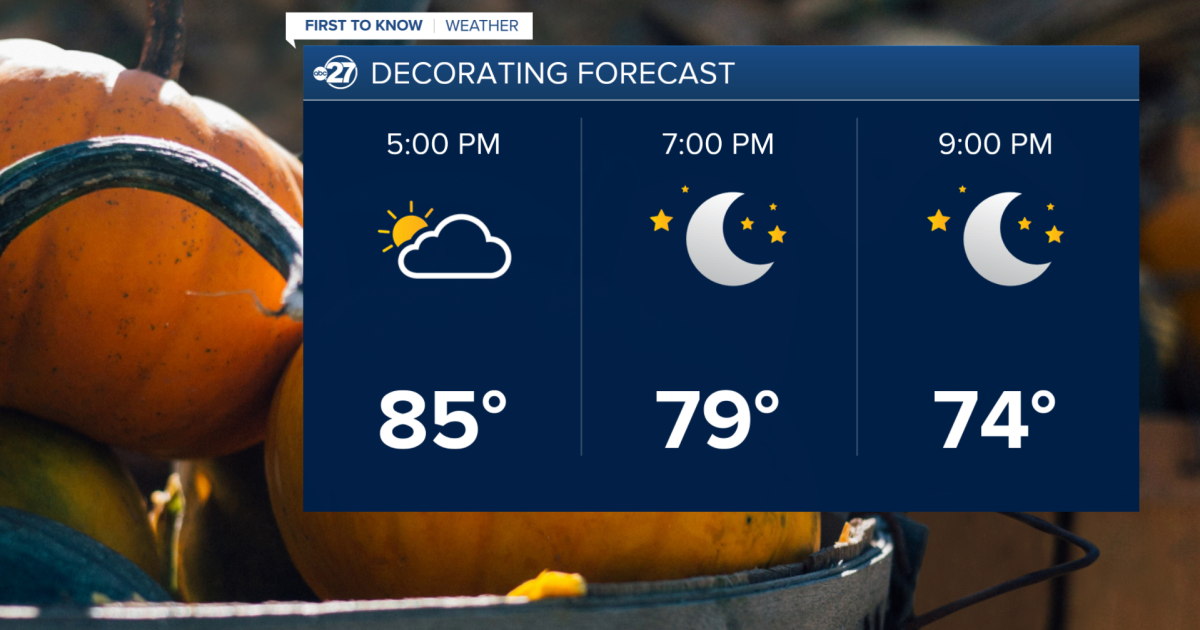 Getting last minute Halloween decorations up in warmer weather Wednesday