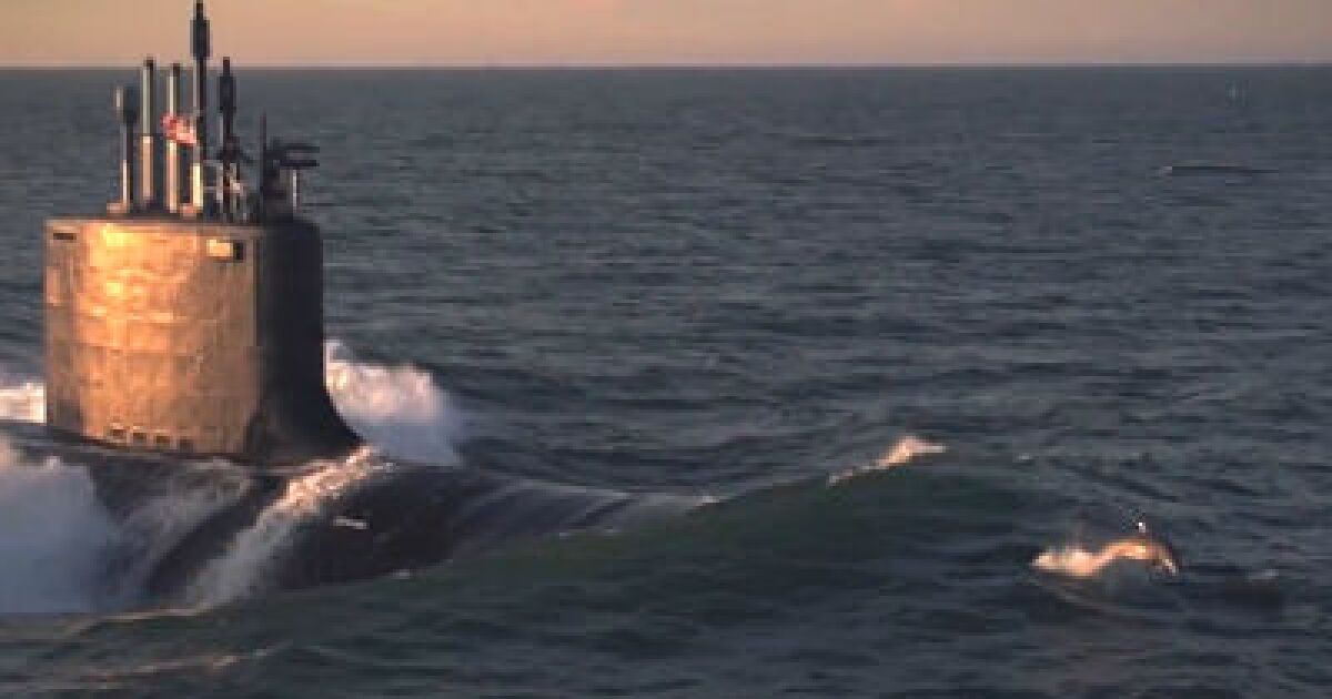 Dolphins surf new submarine’s bow wave (video)