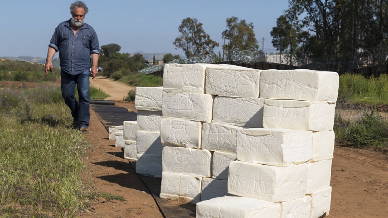 Artist building 'cheese wall' at US-Mexico border