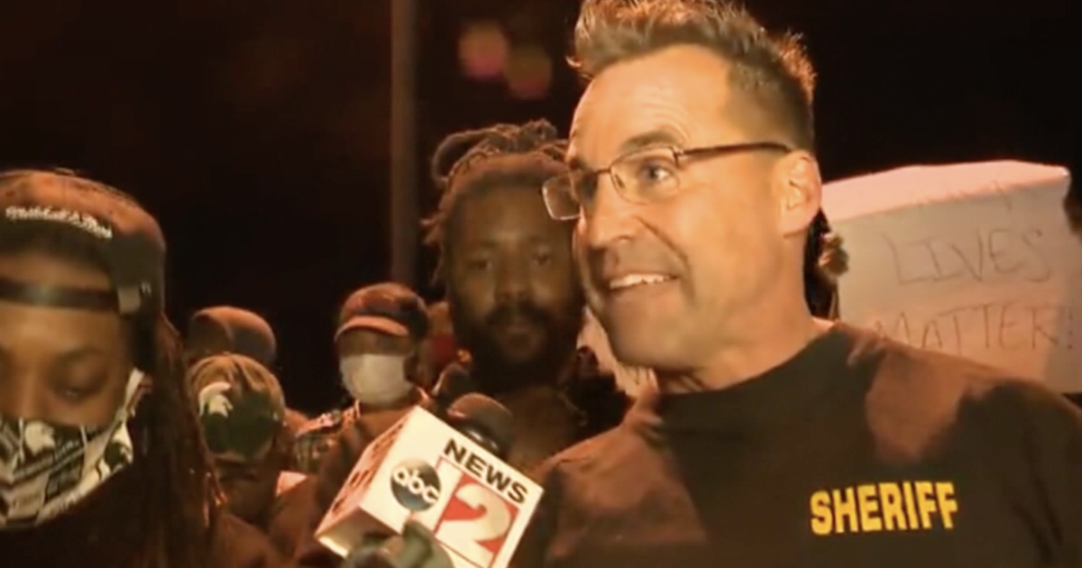 Sheriff joins protesters in Flint: 'These cops love you'