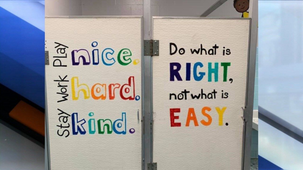 Elementary school students decorate bathrooms with positive messages